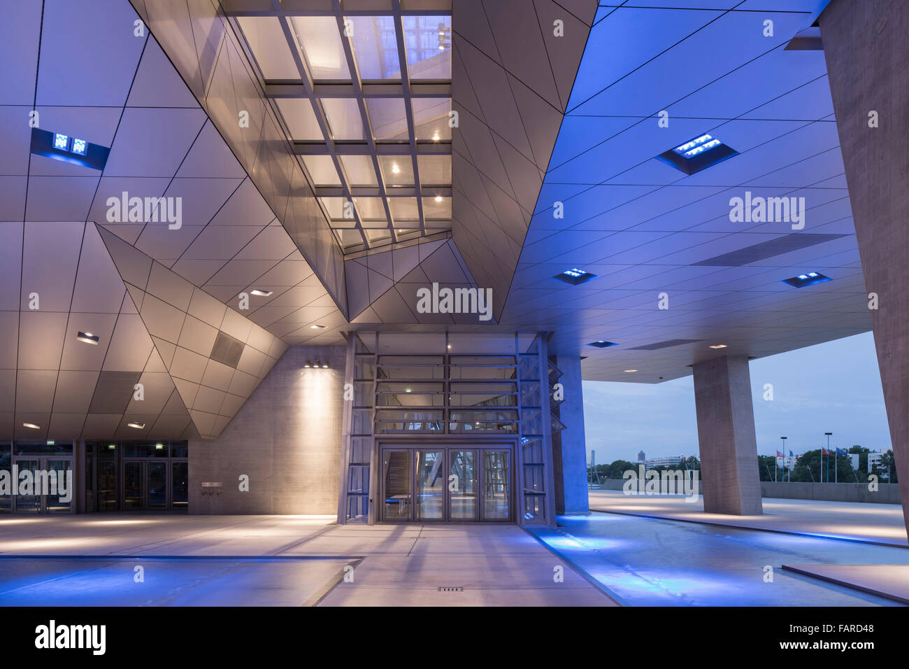 Public space underneath building structure at dusk. Musée des ...