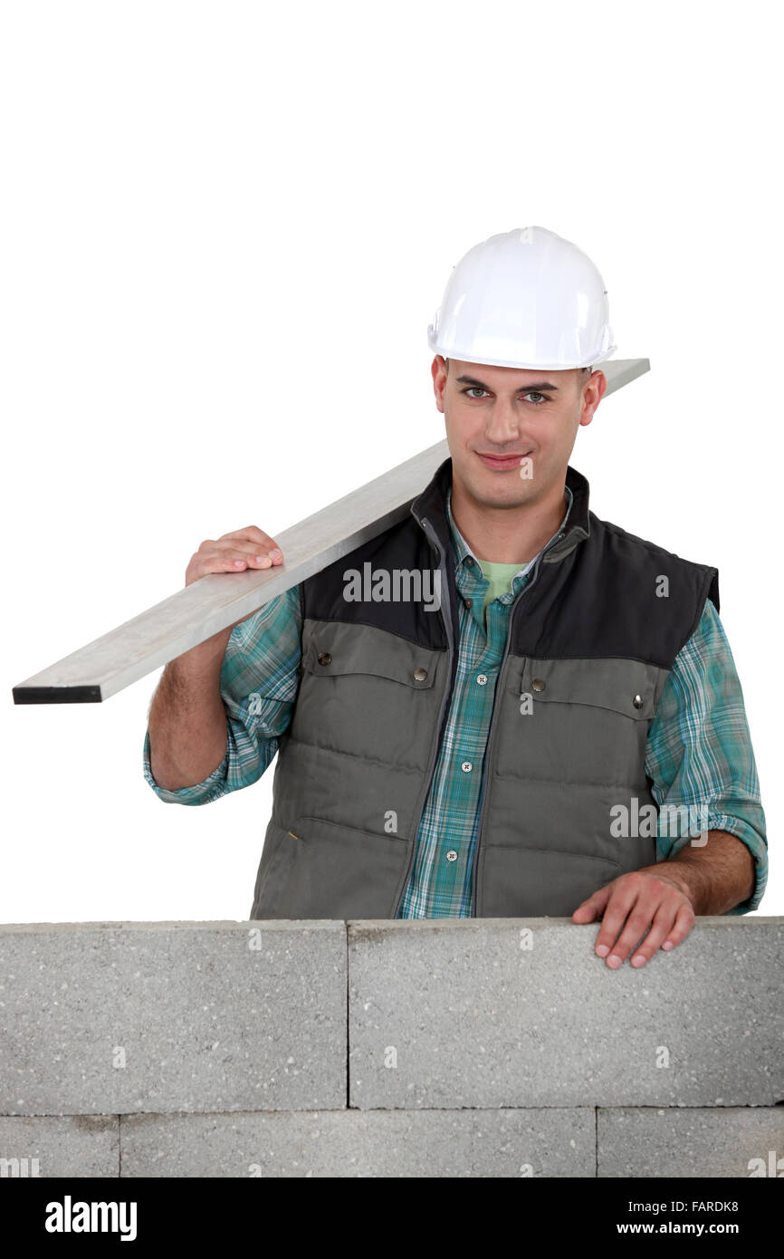 Bricklayer with a wood Stock Photo - Alamy