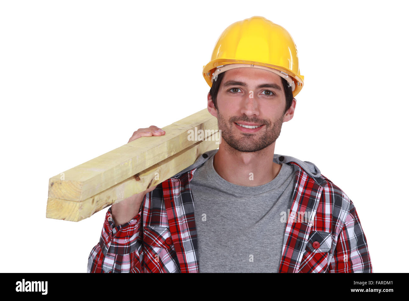 Carpenter carrying planks of wood over shoulder Stock Photo - Alamy