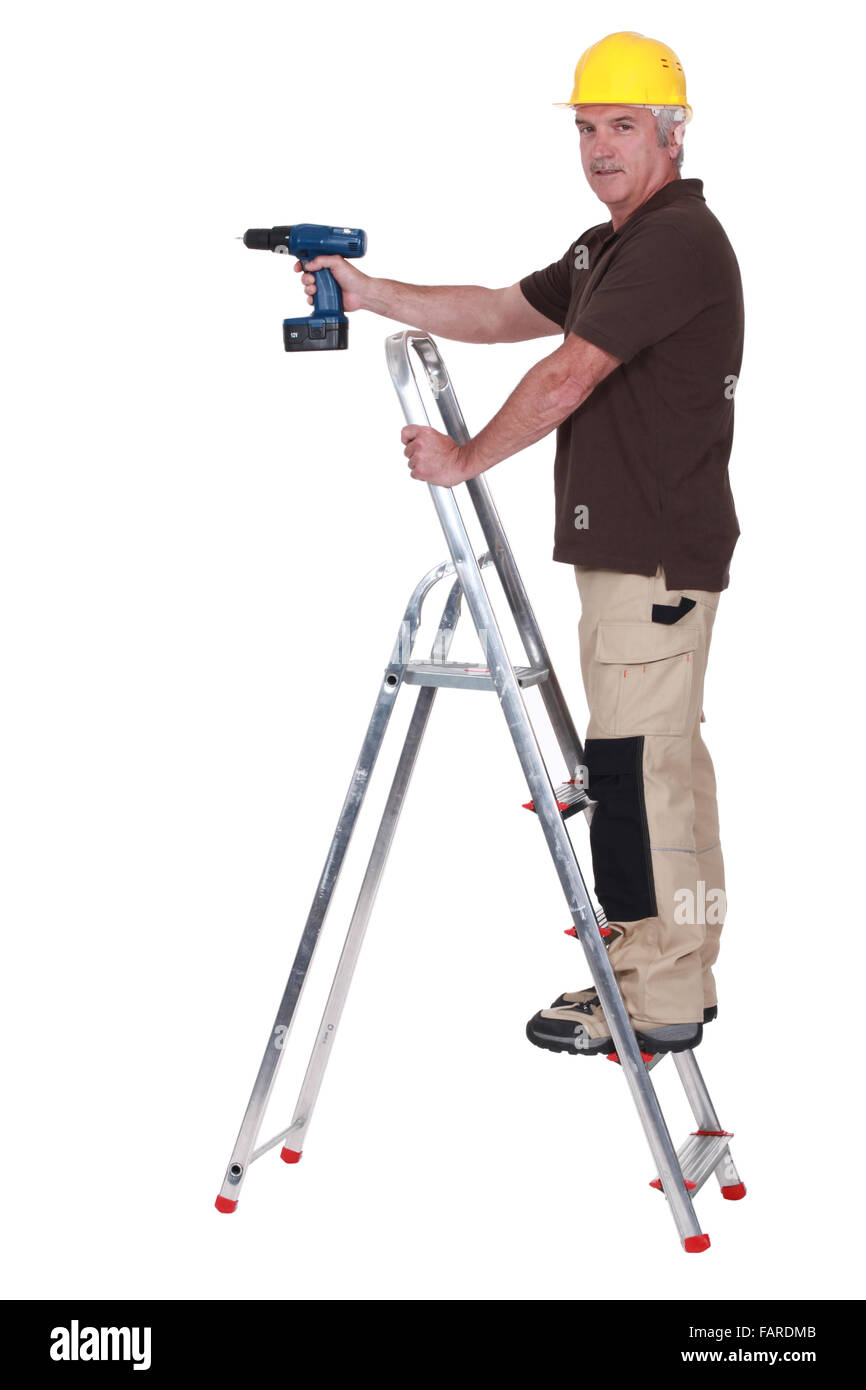 Tradesman using a power tool Stock Photo - Alamy