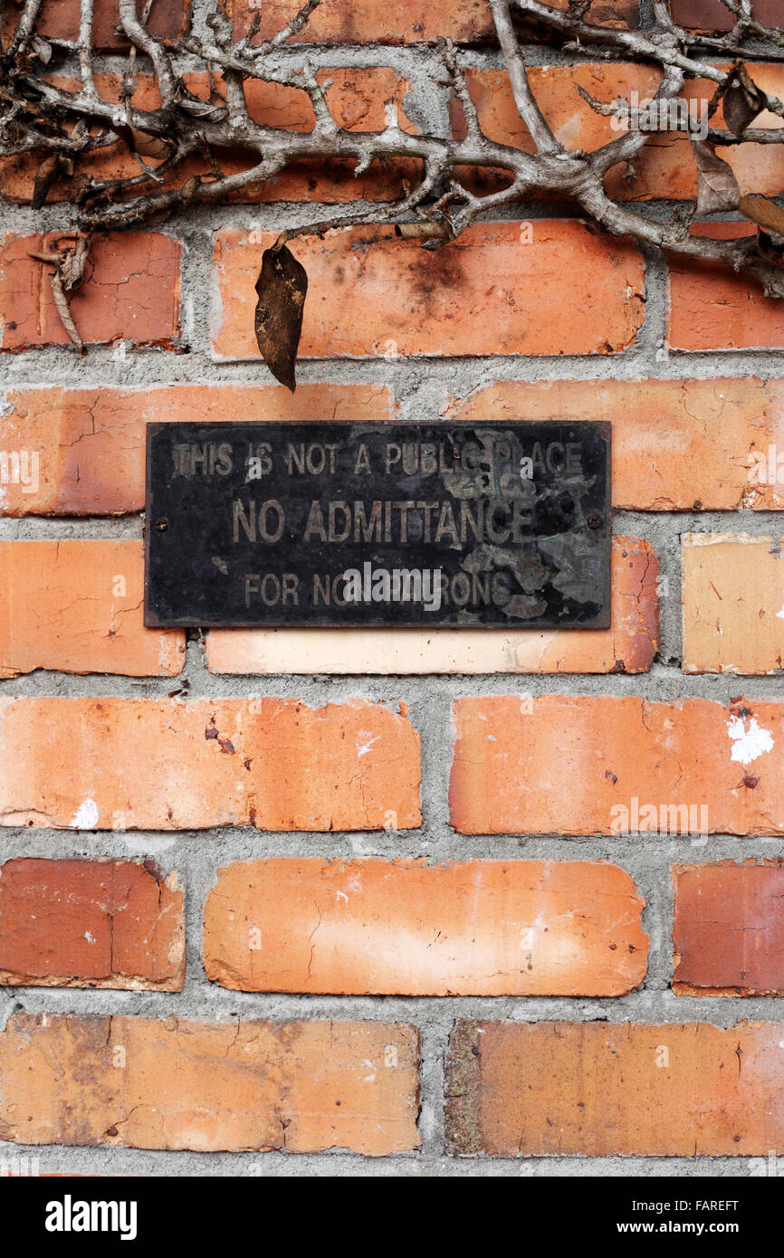 Warning sign on wall Stock Photo - Alamy
