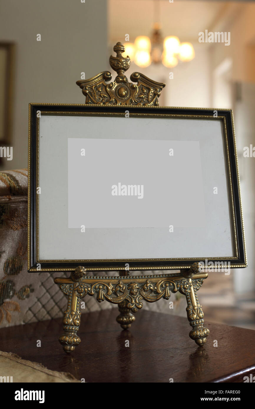 Picture gold frame with a decorative pattern and stand Stock Photo - Alamy