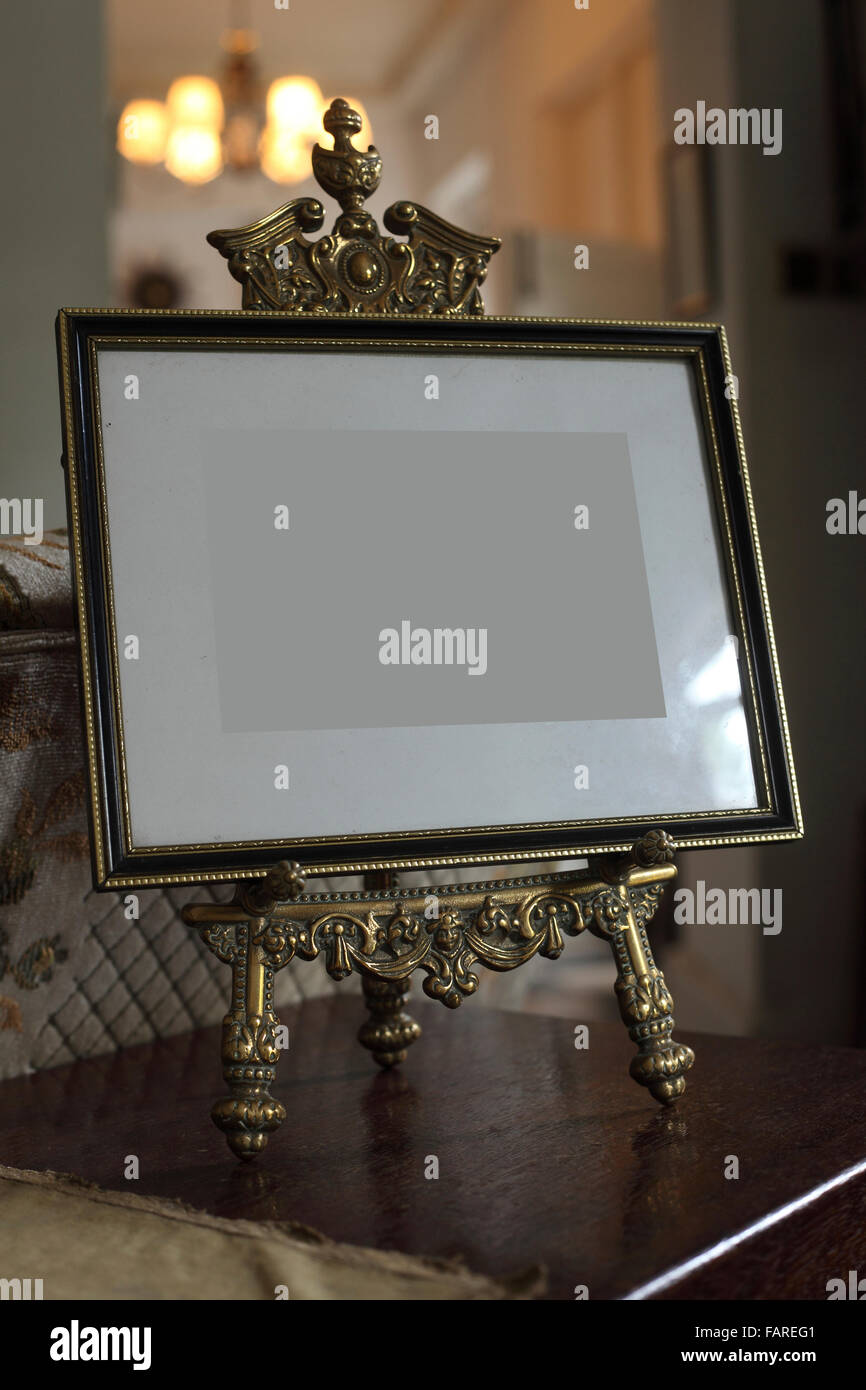Picture gold frame with a decorative pattern and stand Stock Photo - Alamy