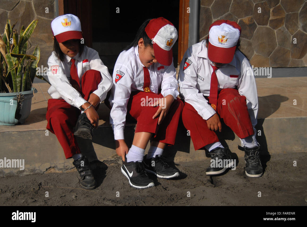 Probolinggo, Indonesia. 04th Jan, 2016. Students take off shoes before ...