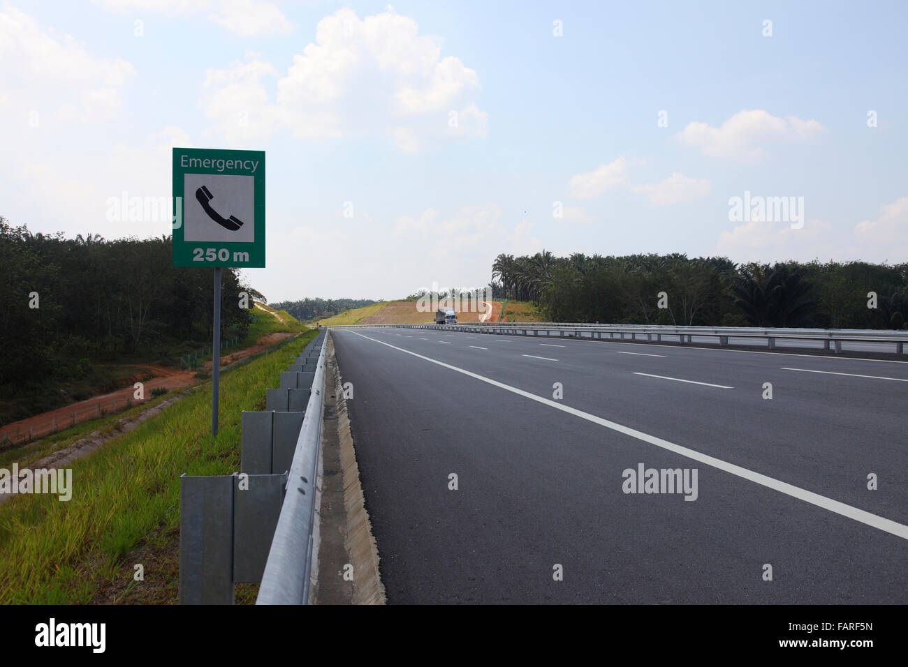 Lorry driving past emergency sign Stock Photo - Alamy