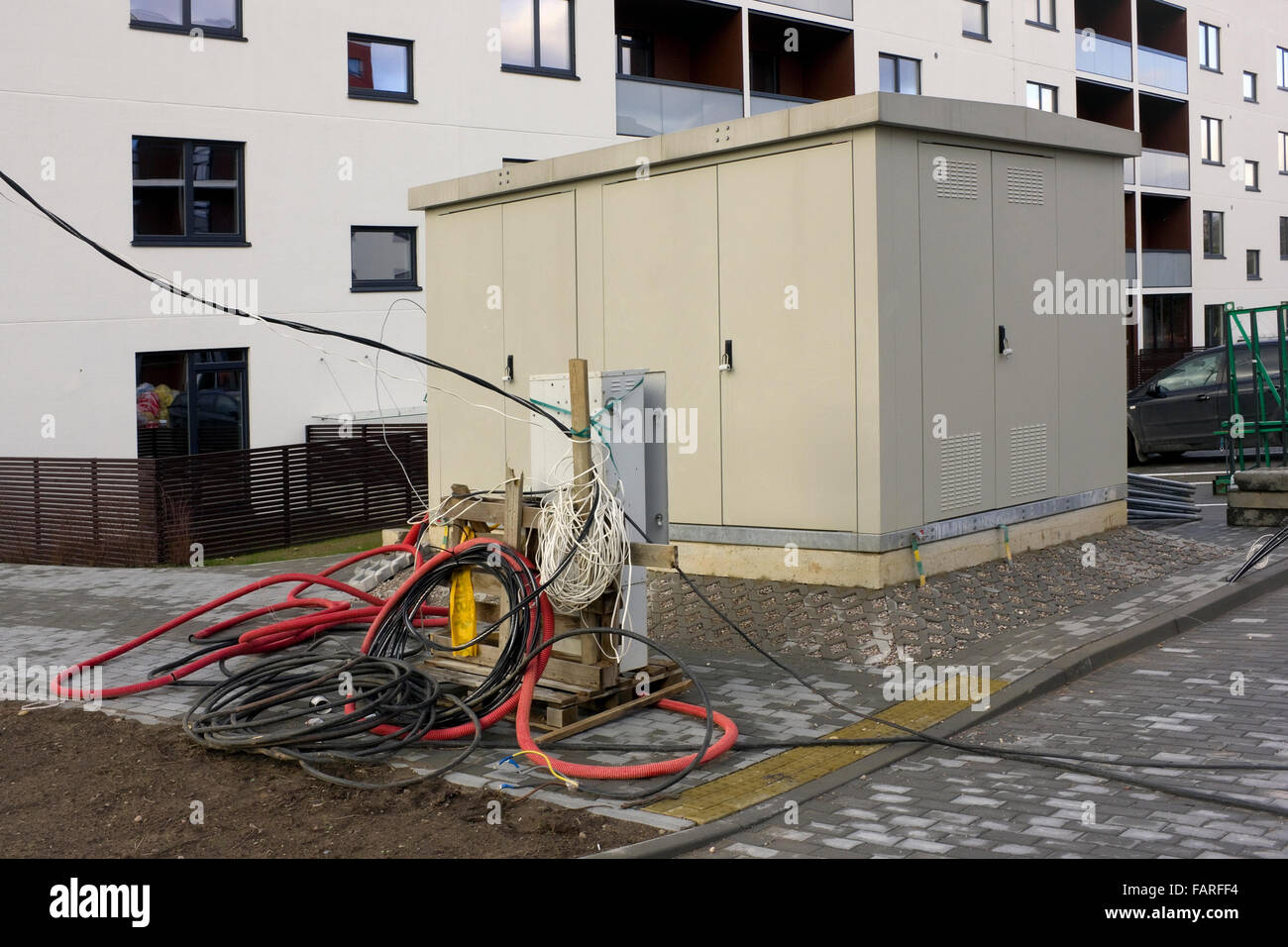 The transformer box and ball of electric cables on street near a new ...