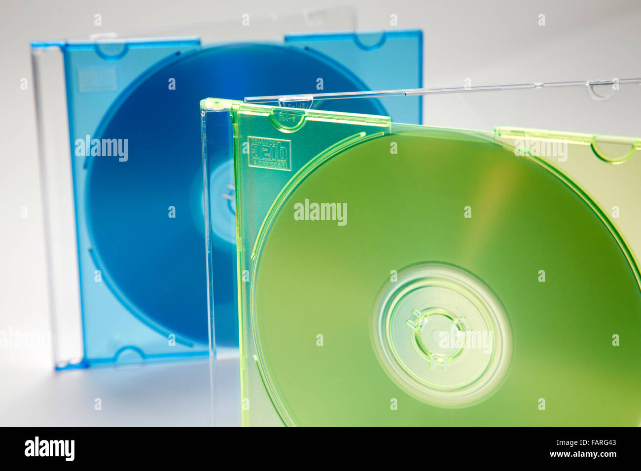 Two computer or music cd with green and blue cd case and blank label ...