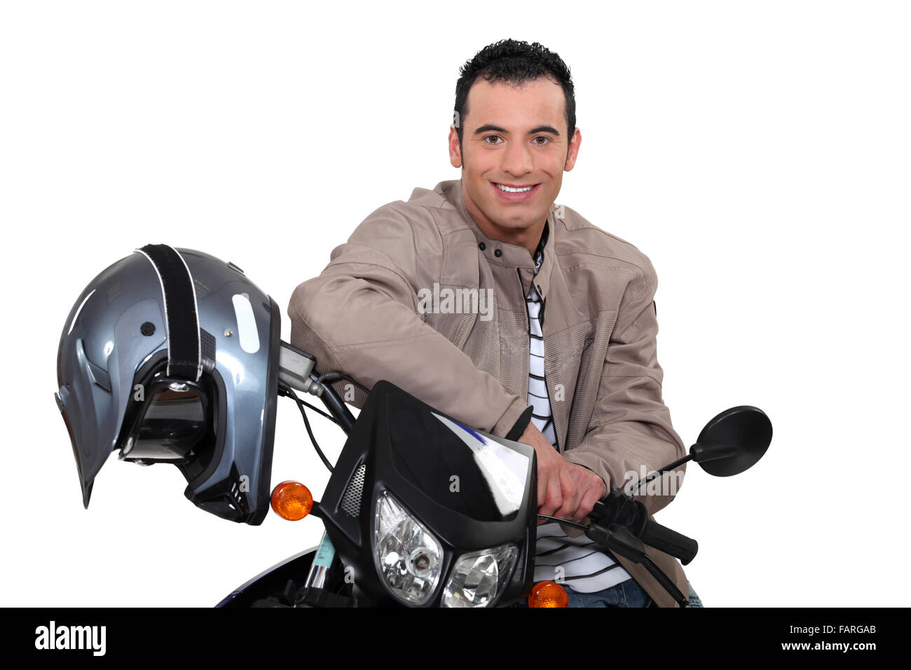 Smiling man sitting on a motorbike Stock Photo - Alamy