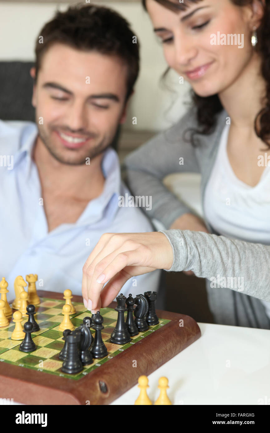 Couple playing chess Stock Photo - Alamy