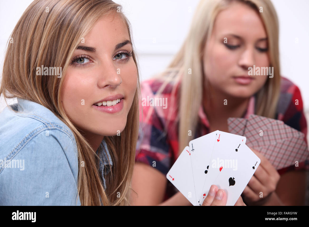 Two girls playing cards Stock Photo - Alamy