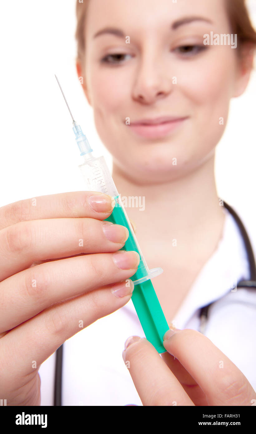 Attractive nurse preparing syringe. All on white background Stock Photo ...