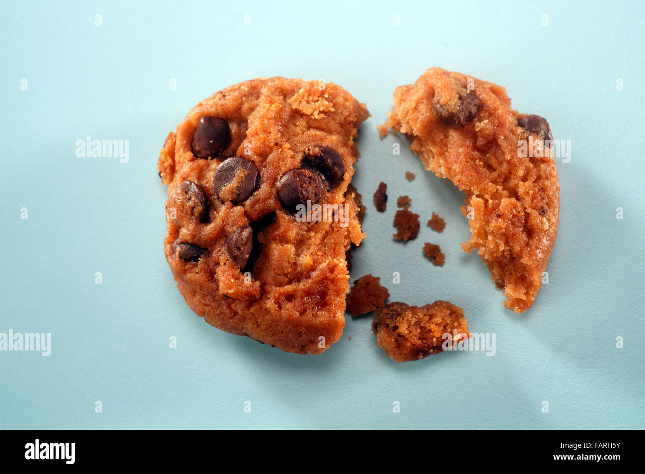Broken chocolate chip cookie on a soft background Stock Photo - Alamy