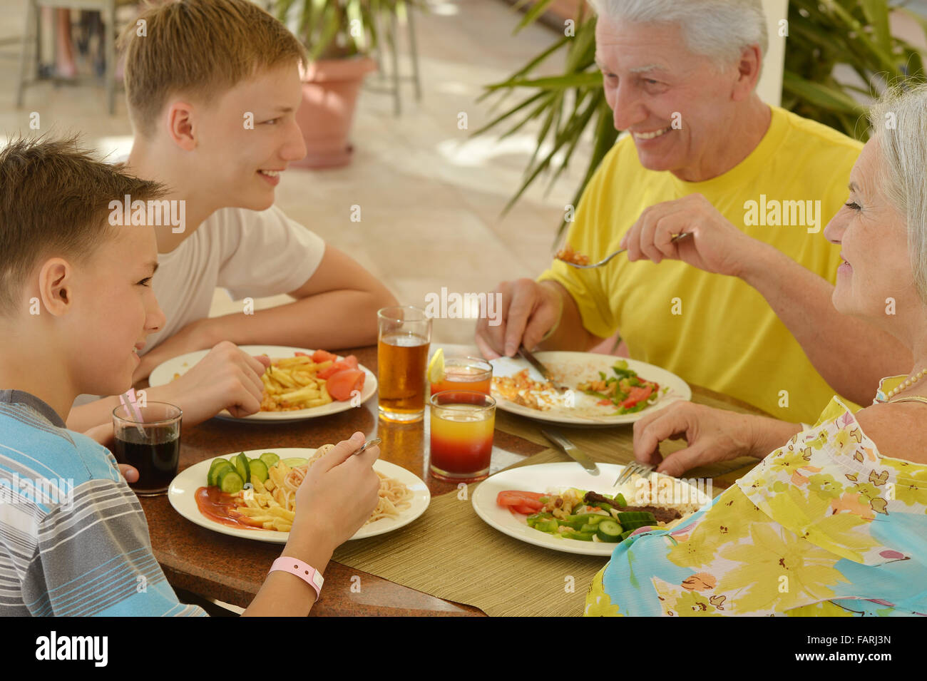 Grandparents with grandchildren at breakfast Stock Photo - Alamy