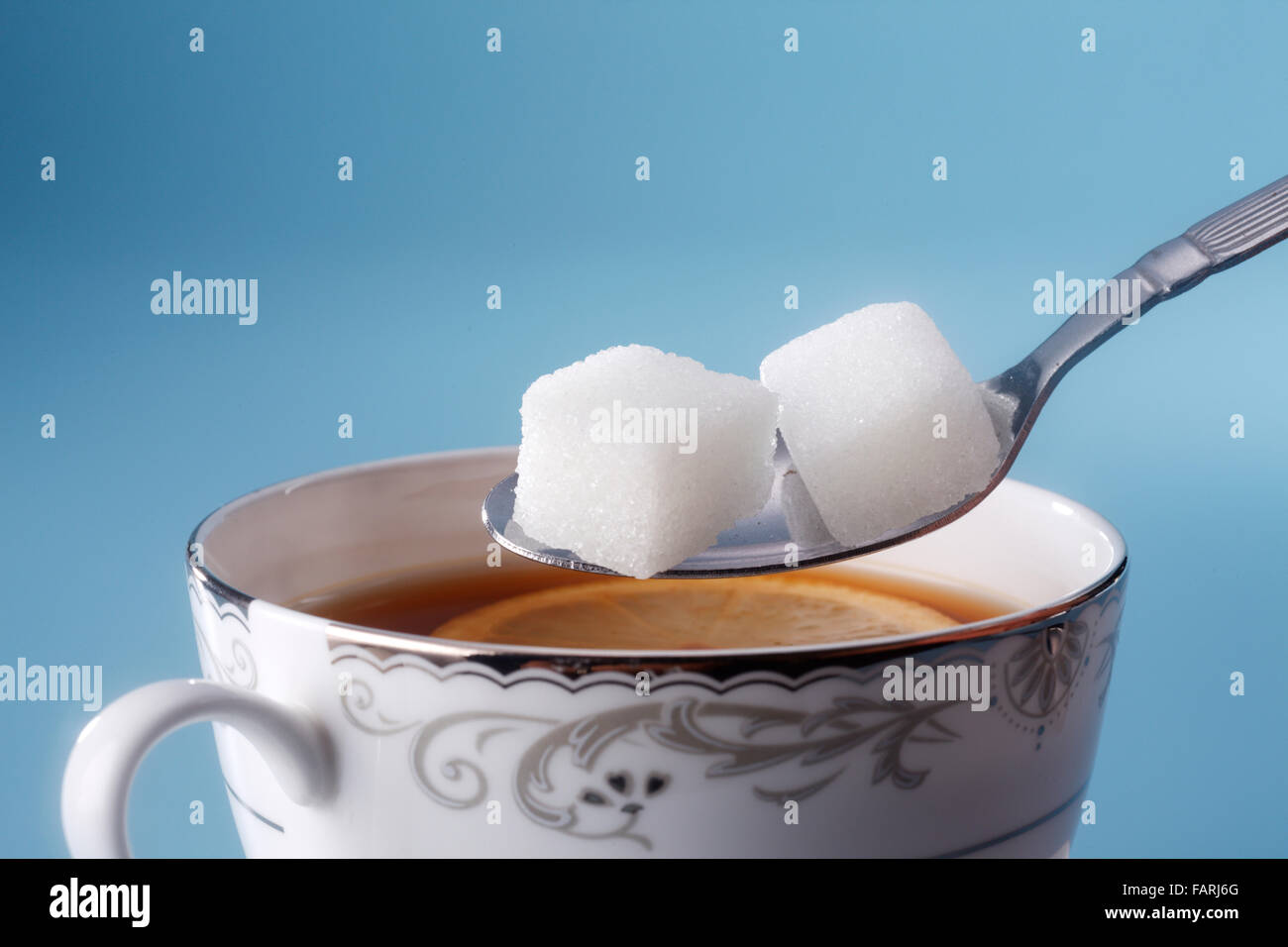 stock image of adding sugar to tea Stock Photo - Alamy