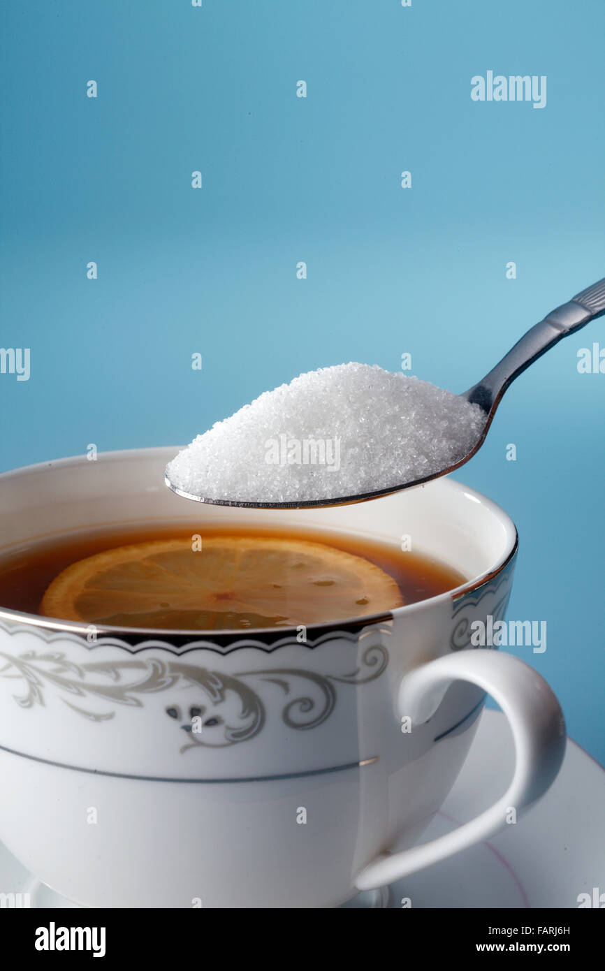 stock image of adding sugar to tea Stock Photo - Alamy