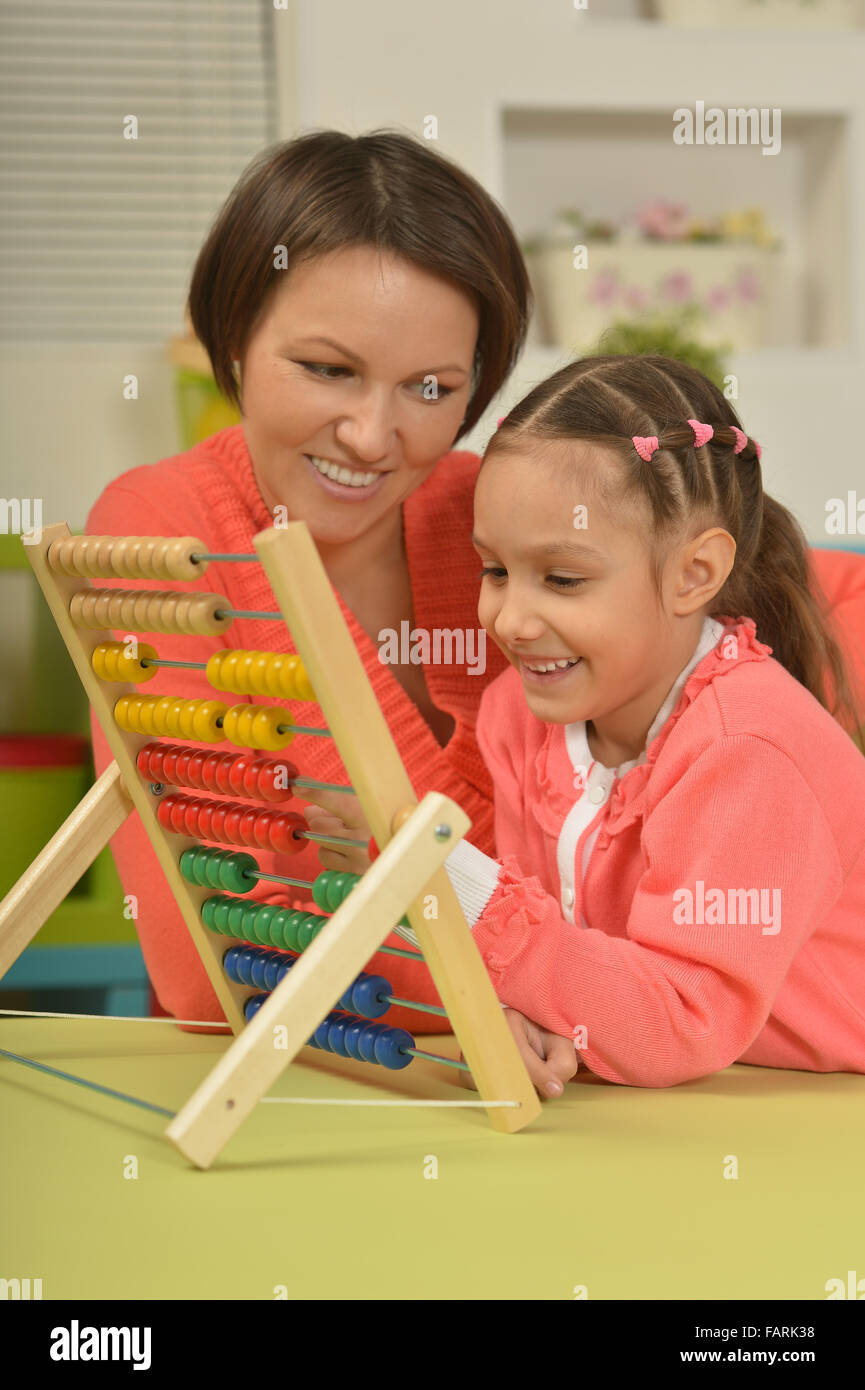 girl doing math exercises with mother Stock Photo - Alamy