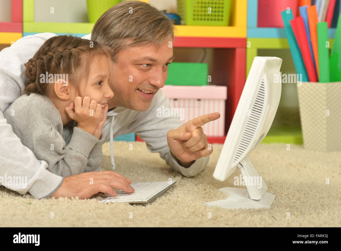 father and little daughter with computer Stock Photo - Alamy