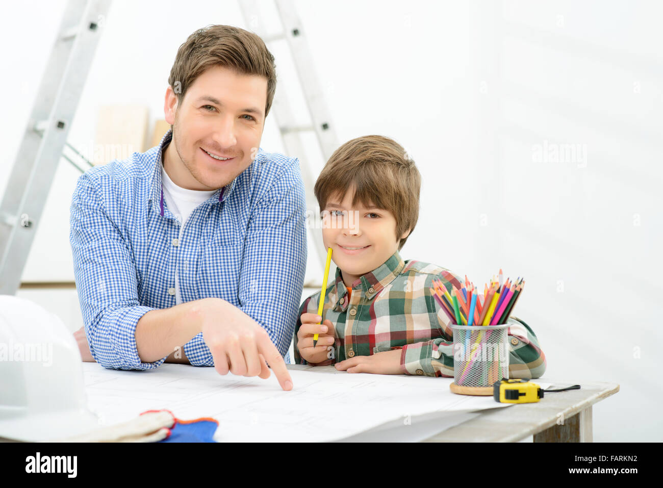 Cheerful father and daughter making project Stock Photo - Alamy