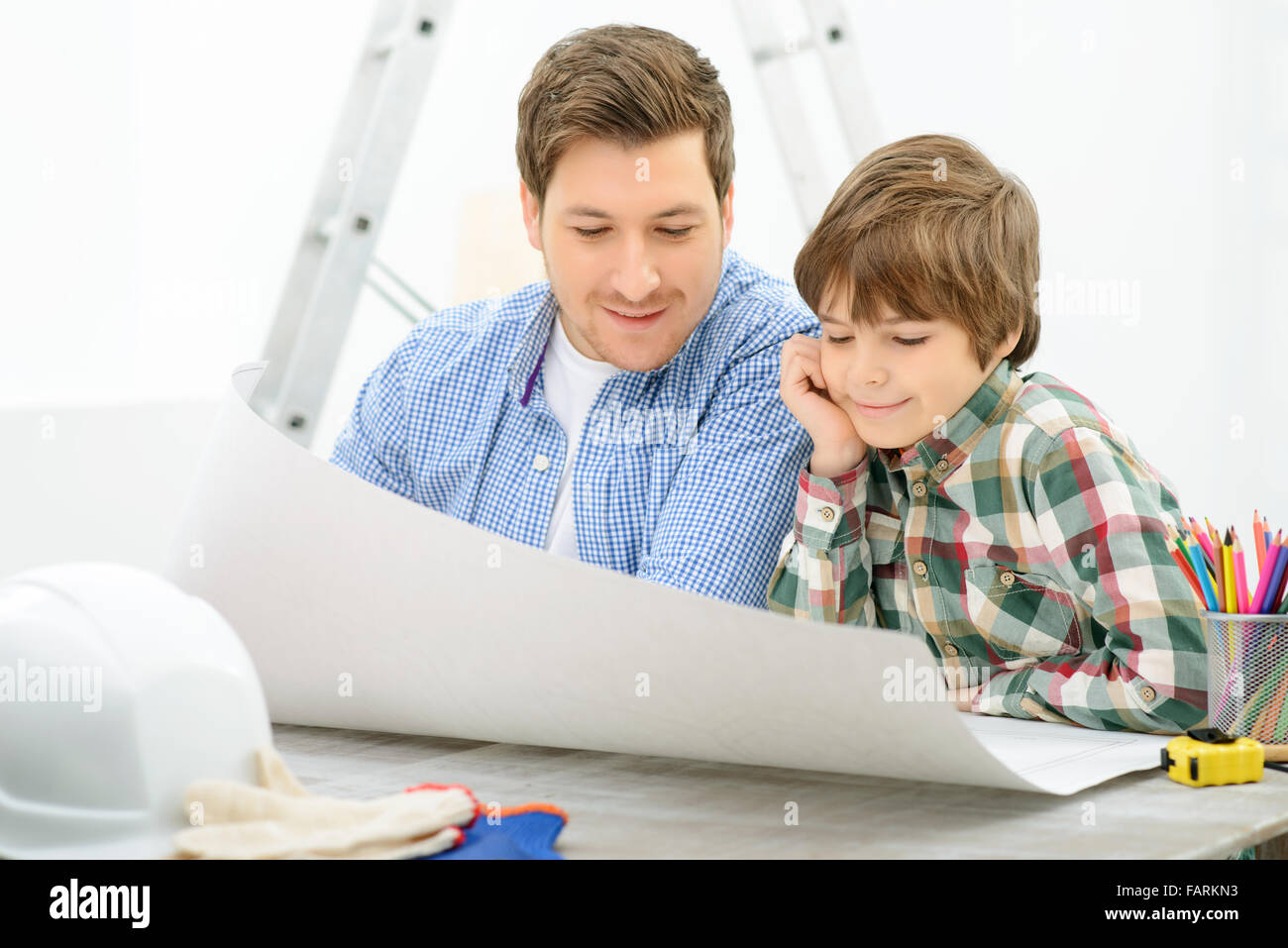 Cheerful father and daughter making project Stock Photo - Alamy