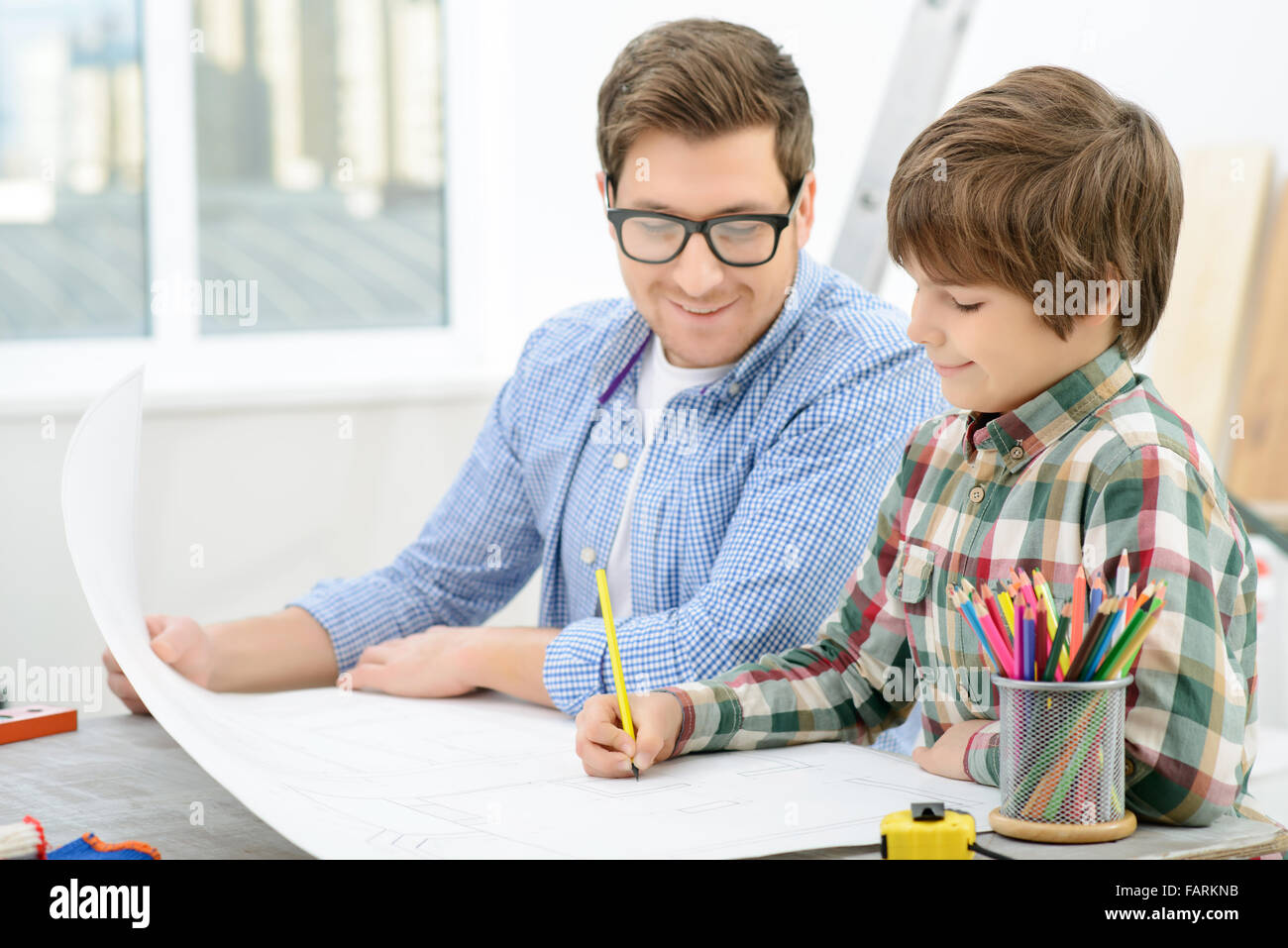 Cheerful father and daughter making project Stock Photo - Alamy