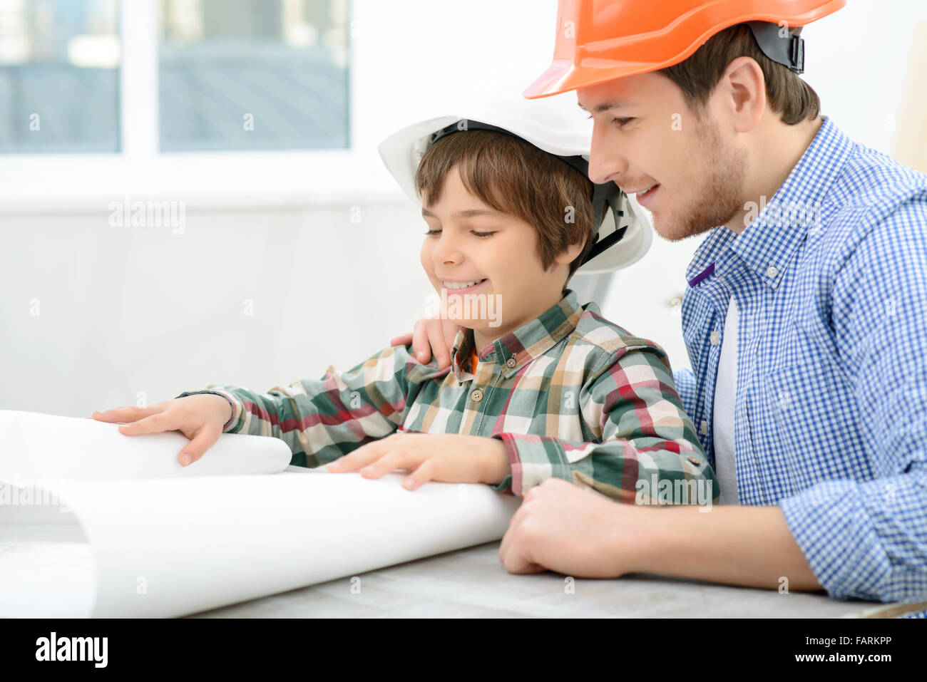Cheerful father and son making renovation Stock Photo - Alamy