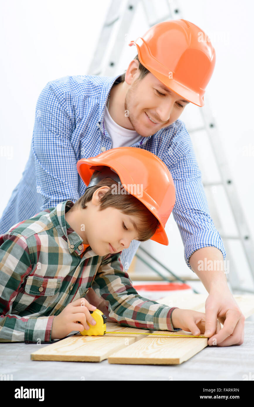 Positive boy holding tape measure Stock Photo - Alamy
