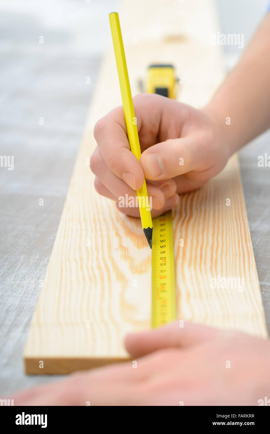 Positive boy holding tape measure Stock Photo - Alamy
