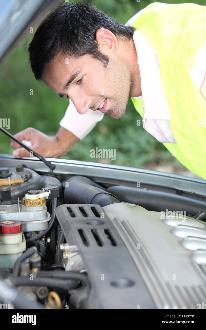 Man looking at a car engine Stock Photo - Alamy