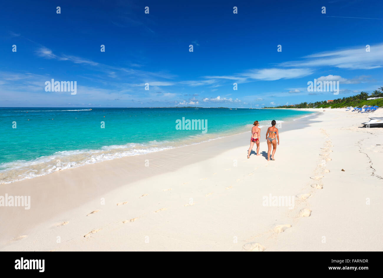 Two girls walk on sand beach in Nassau (Paradise island), Bahamas Stock ...