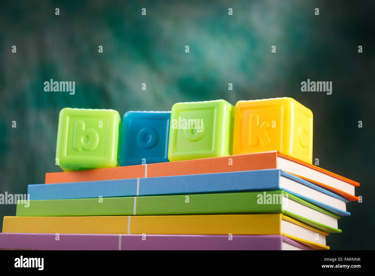 Blocks on a stack of books Stock Photo - Alamy