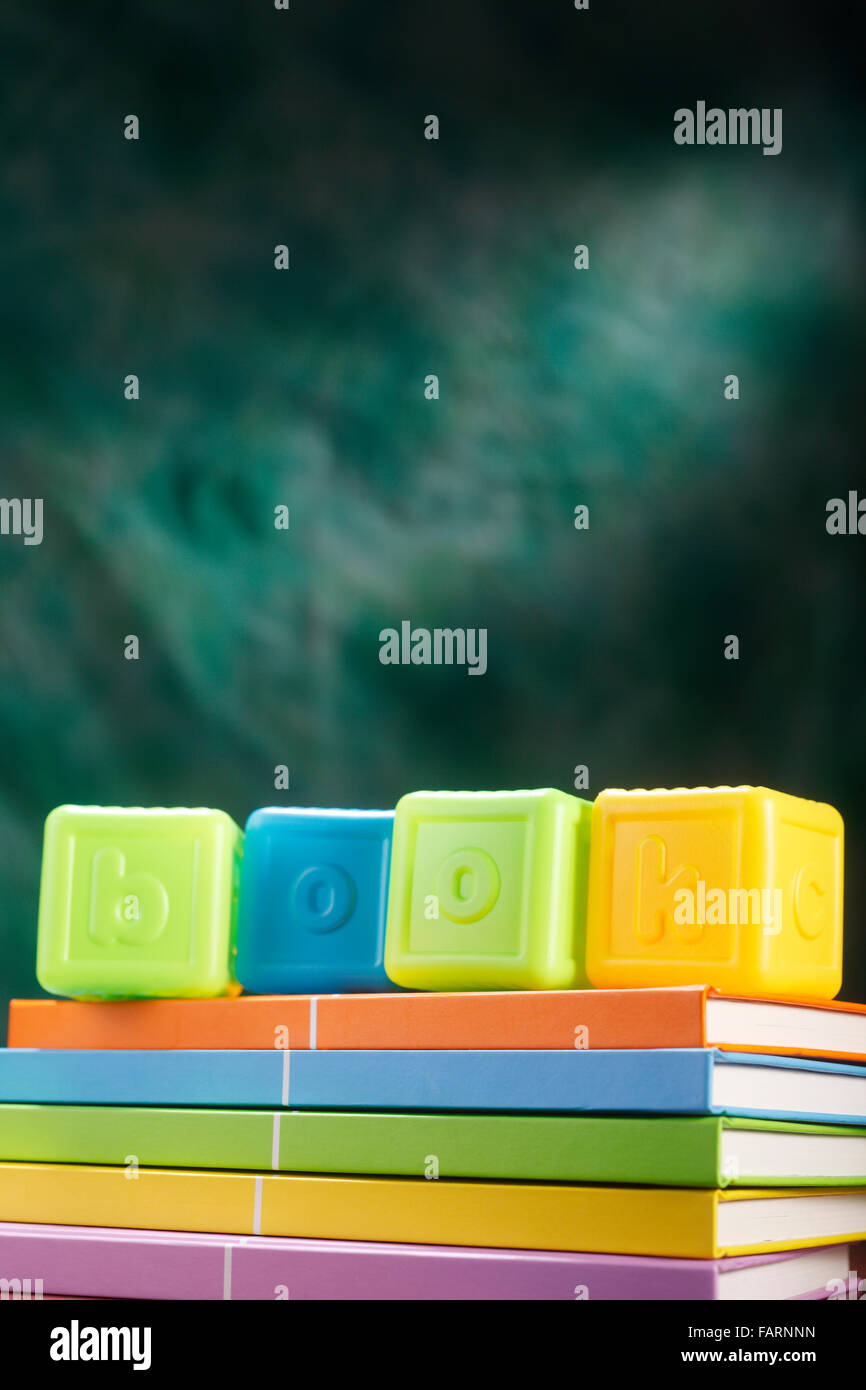 Blocks on a stack of books Stock Photo - Alamy