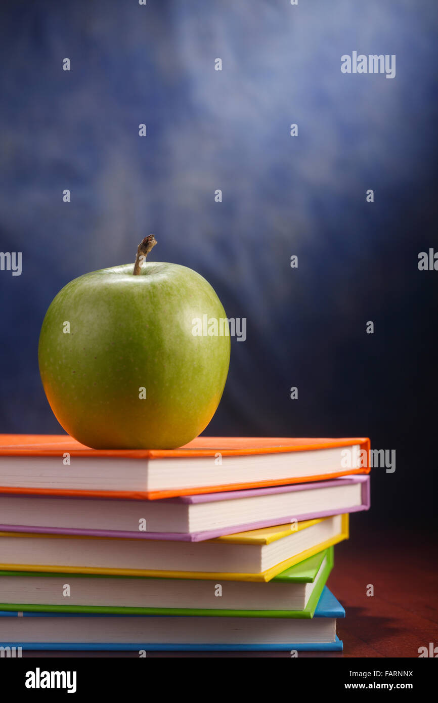 An apple on a stack of books Stock Photo - Alamy