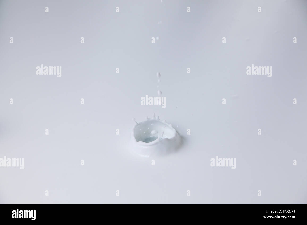 Milk droplet forming a crown Stock Photo - Alamy