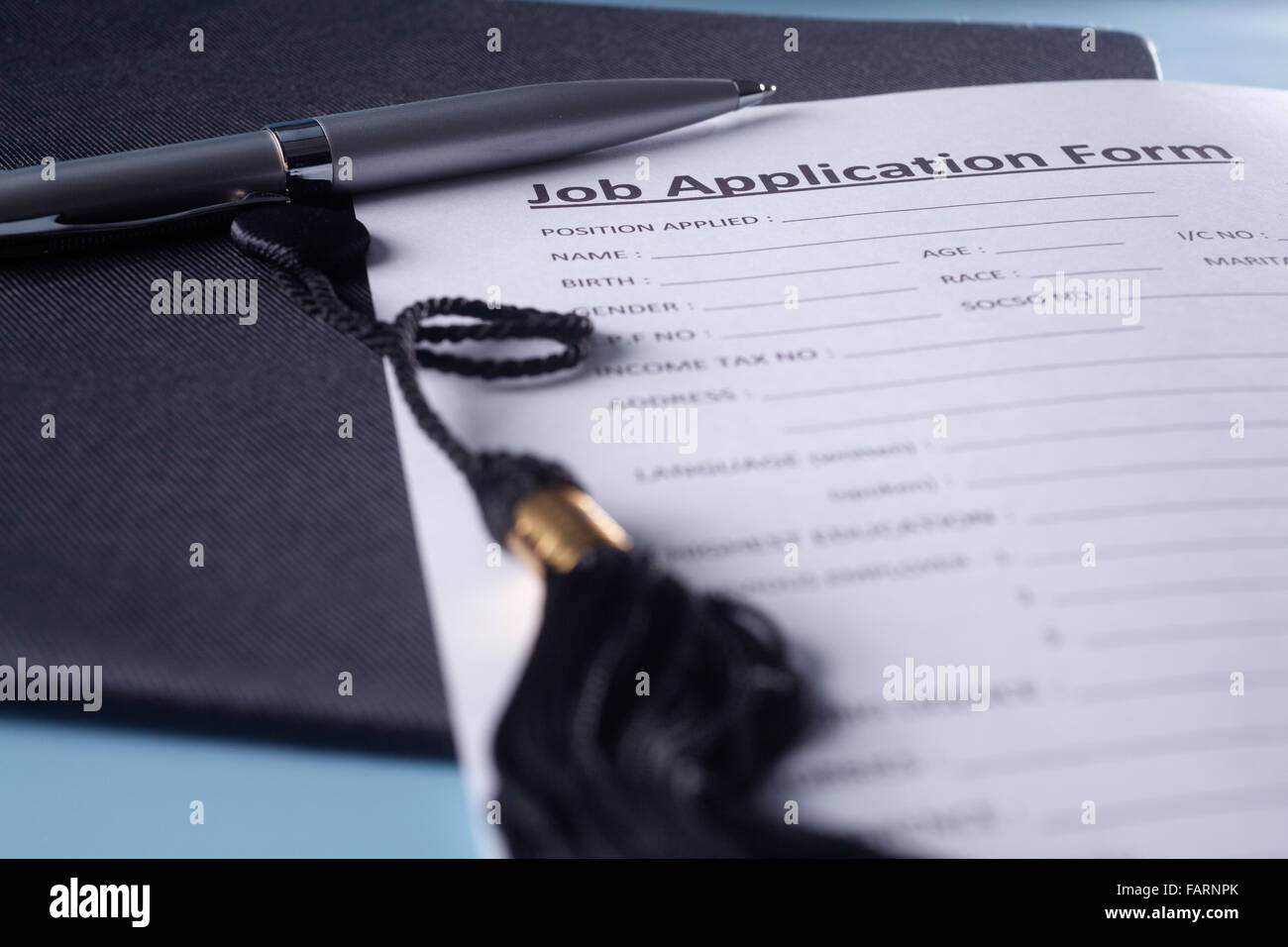 Graduation hat with application form Stock Photo - Alamy