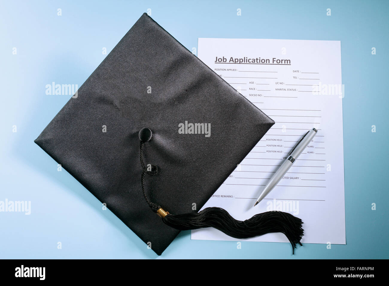 Graduation hat with application form Stock Photo - Alamy