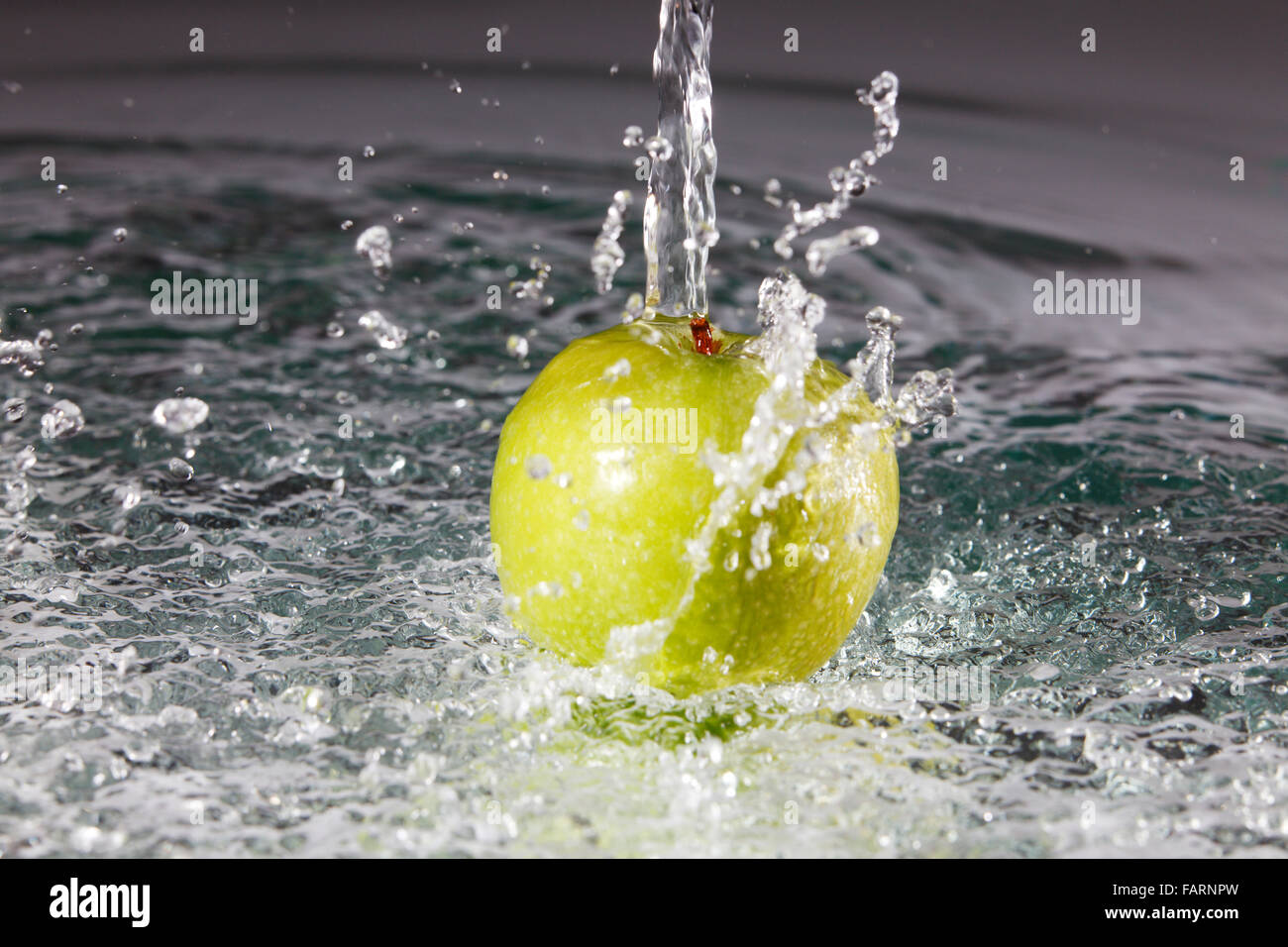 Water being poured onto apple Stock Photo - Alamy