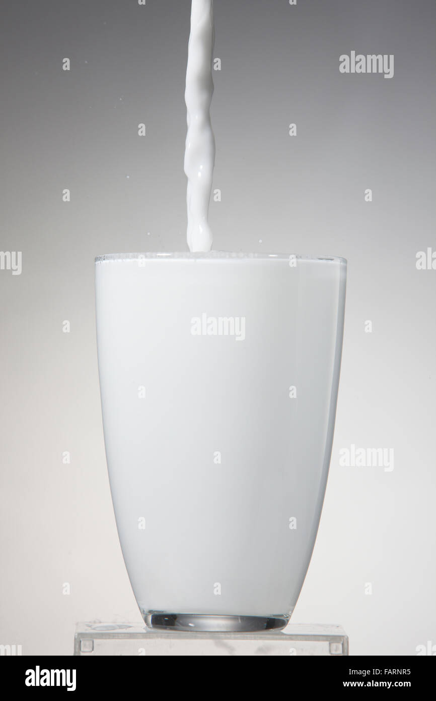 stock image of pouring milk to glass Stock Photo - Alamy
