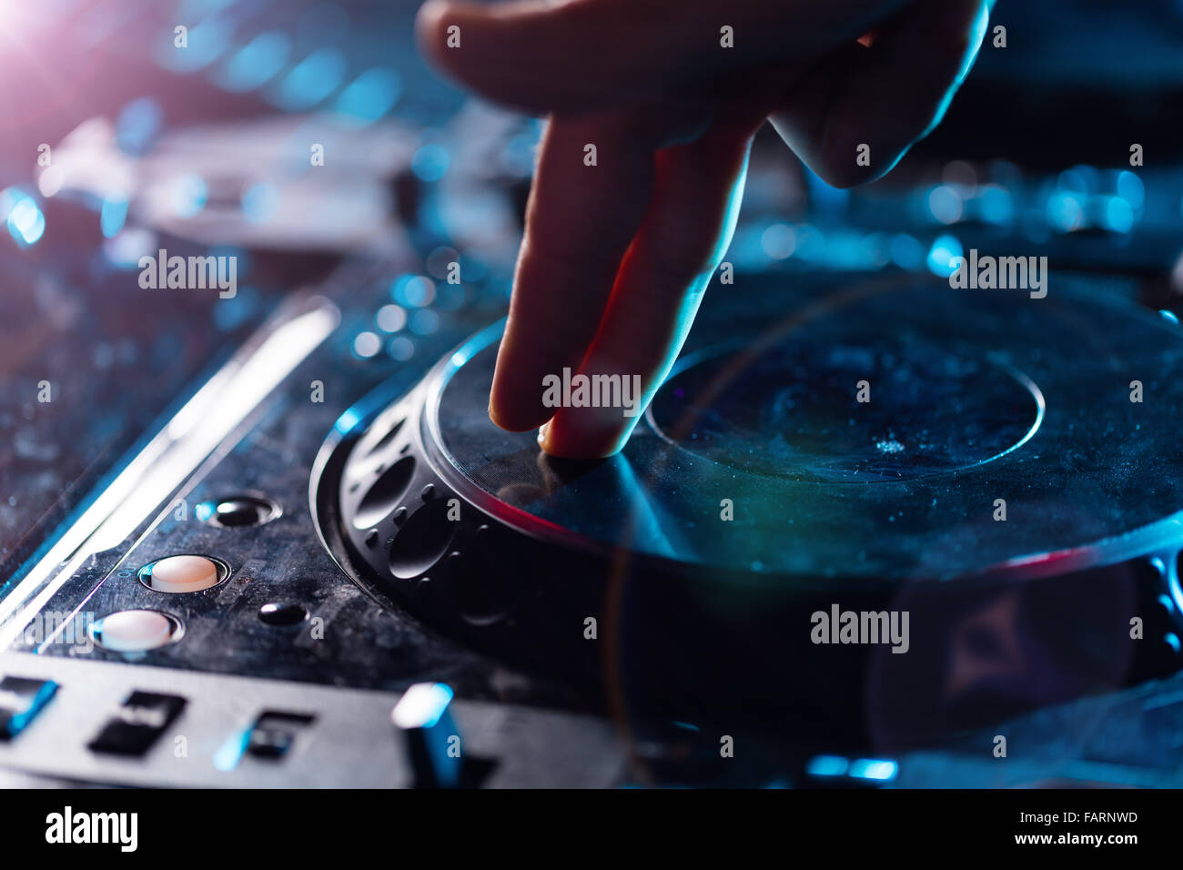Detail of dj's hands operating on console Stock Photo - Alamy