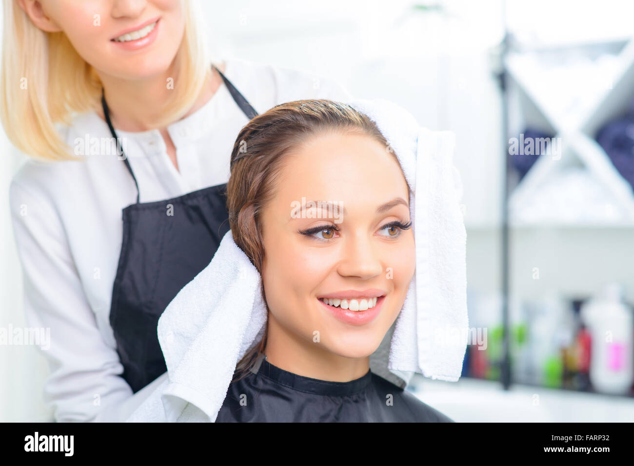 Stylist is drying off clients hair Stock Photo - Alamy
