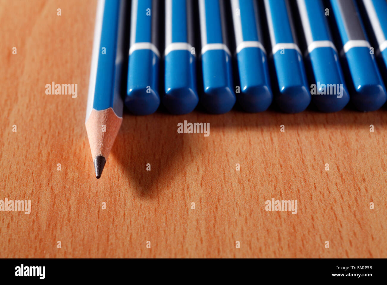 A sharpened pencil among a row of blunt end pencils Stock Photo - Alamy