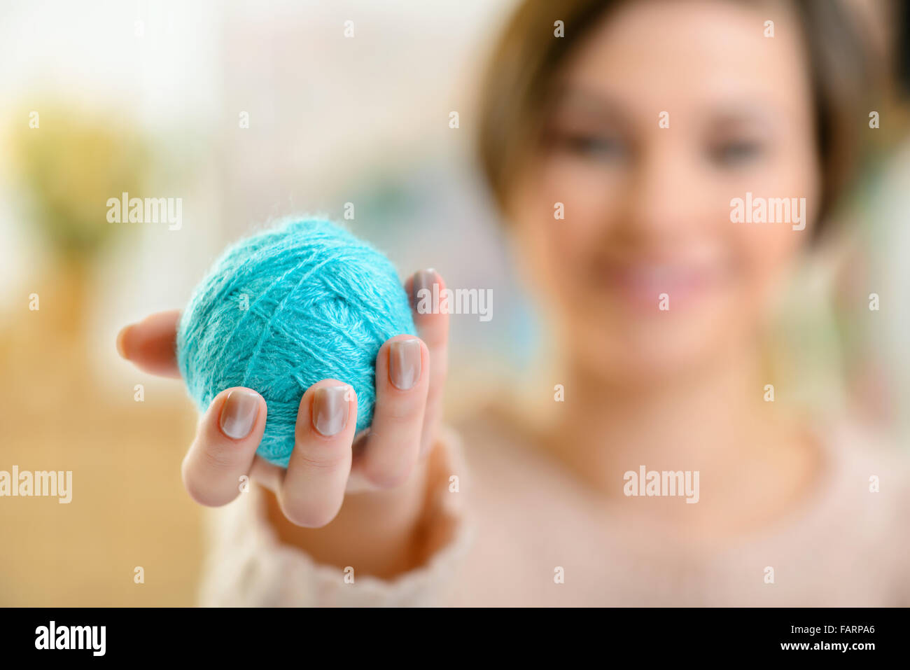 Young girl holding a wool yarn Stock Photo - Alamy