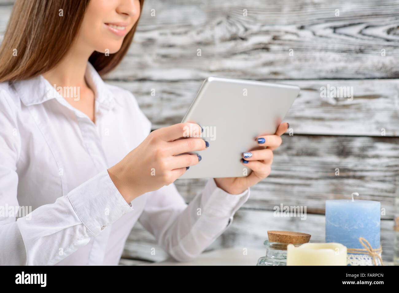 Nice woman holding tablet Stock Photo - Alamy