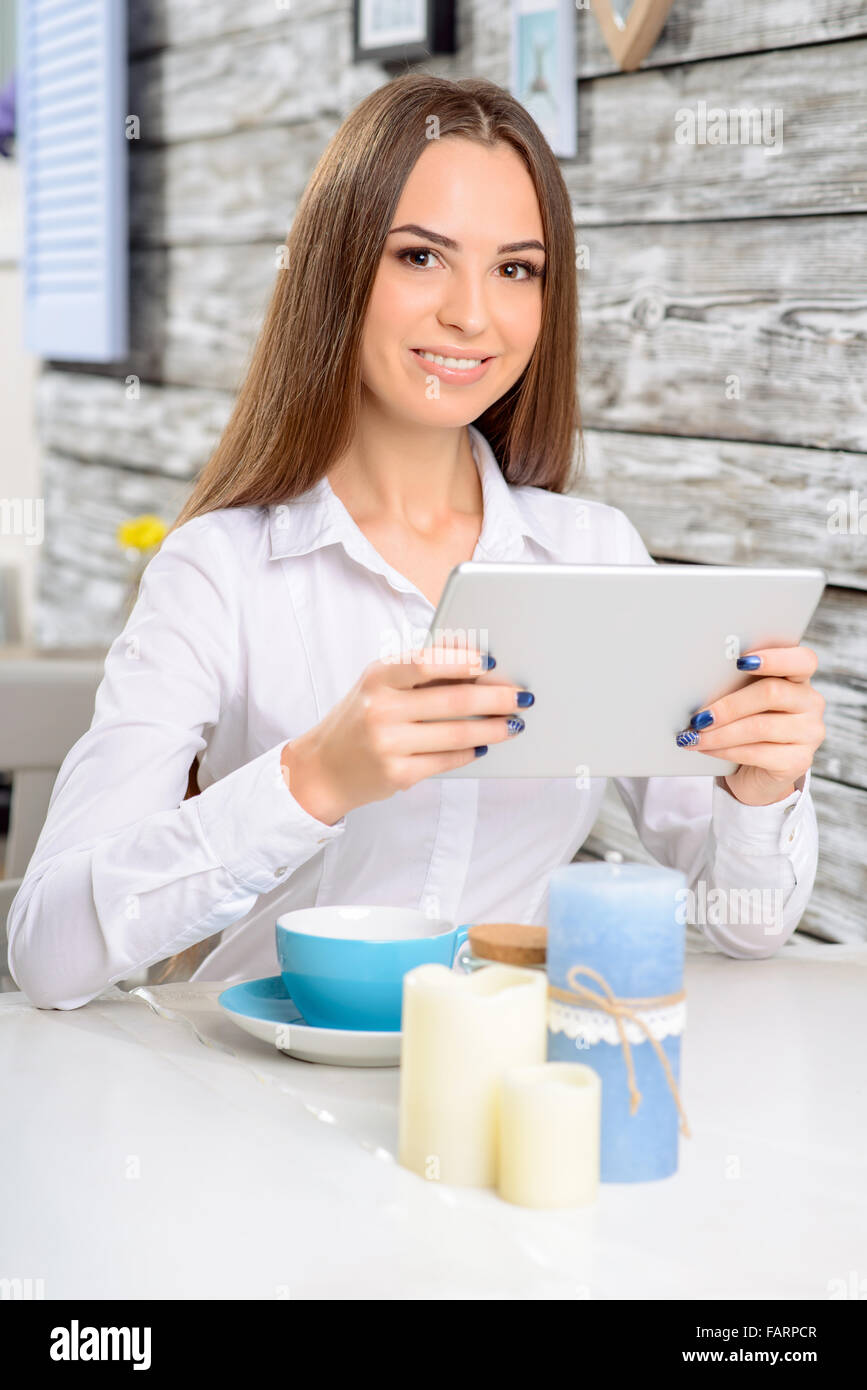 Nice woman holding tablet Stock Photo - Alamy