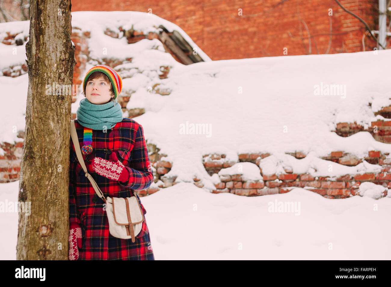 Girl standing near the tree in winter Stock Photo - Alamy