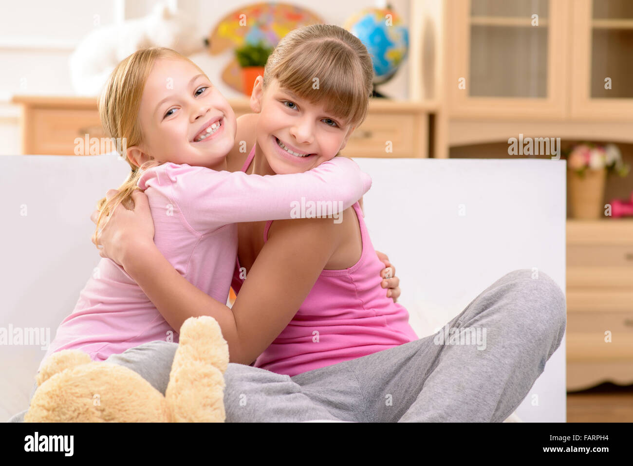 Sisters embracing hi-res stock photography and images - Alamy