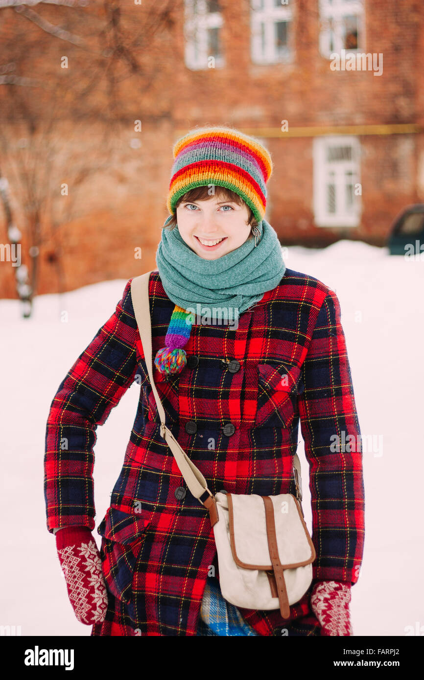 Girl in red checkered coat standing at old town background Stock Photo ...