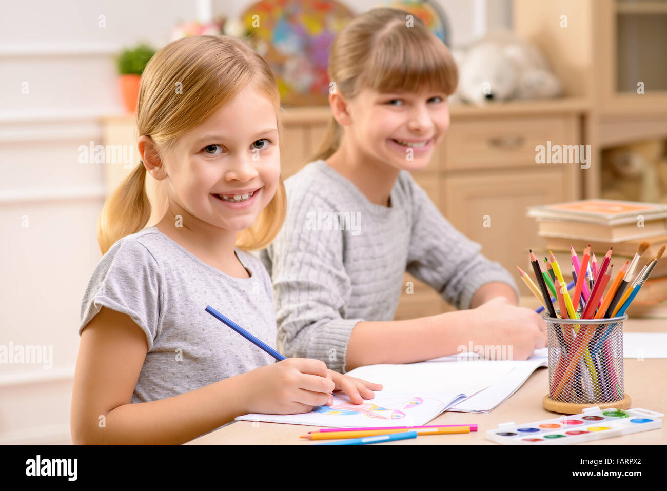 Pleasant little girl drawing Stock Photo - Alamy
