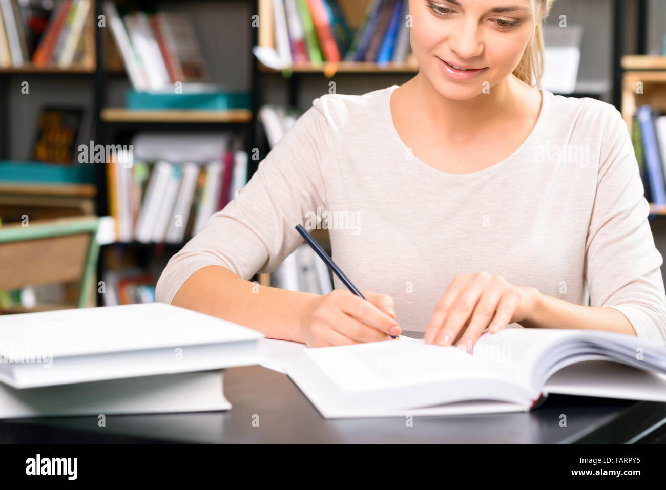 Young girl doing her home assignment Stock Photo - Alamy