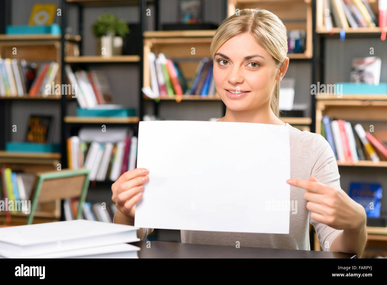 Young girl is holding a sheet of paper Stock Photo - Alamy