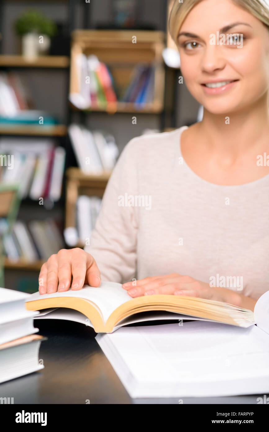 Young woman working with numerous books Stock Photo - Alamy